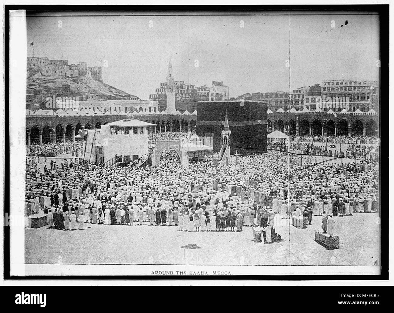 Photograph of Muslim pilgrims gathered around the Kaaba, a sacred ...