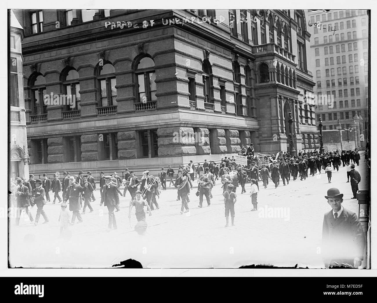 The photograph shows a parade in New York featuring unemployed marchers ...