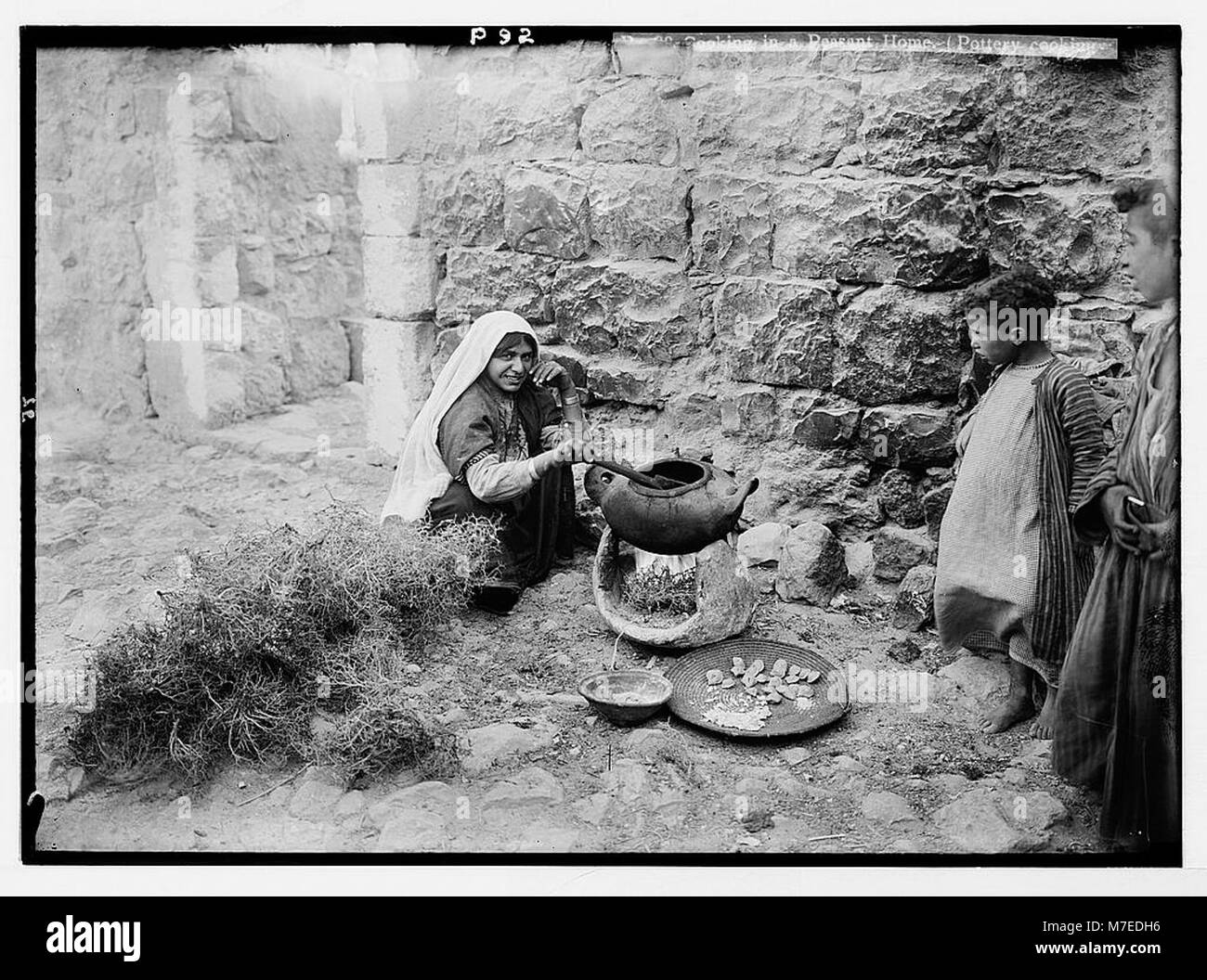 This image portrays peasant life, showing individuals cooking in a ...