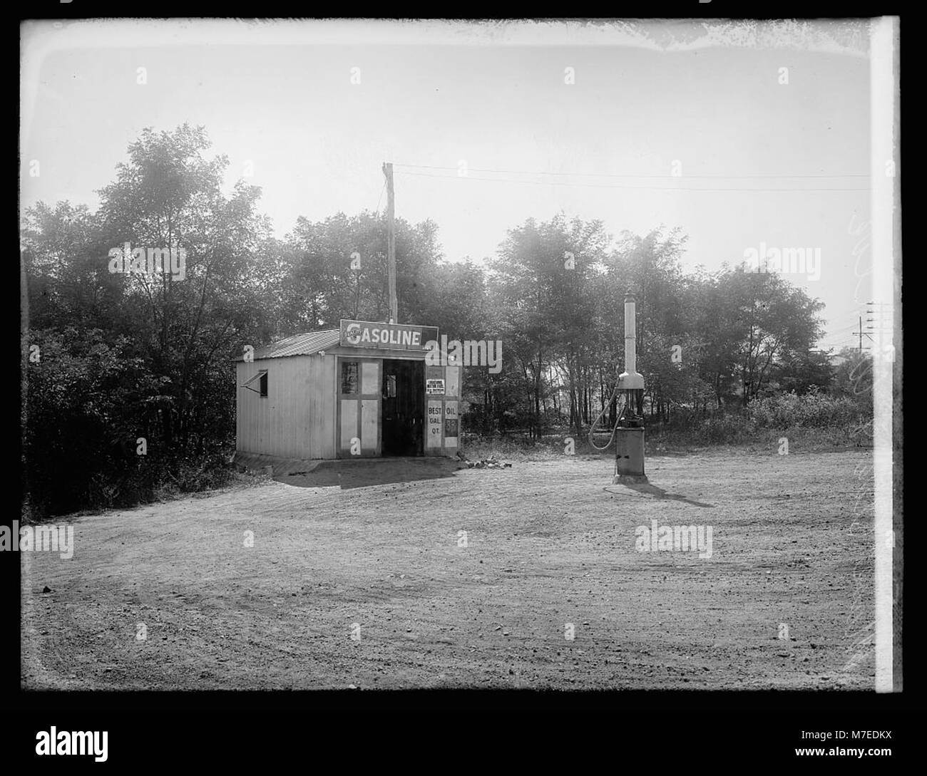 A historical photograph of the Penn Oil Company station located at Mass ...