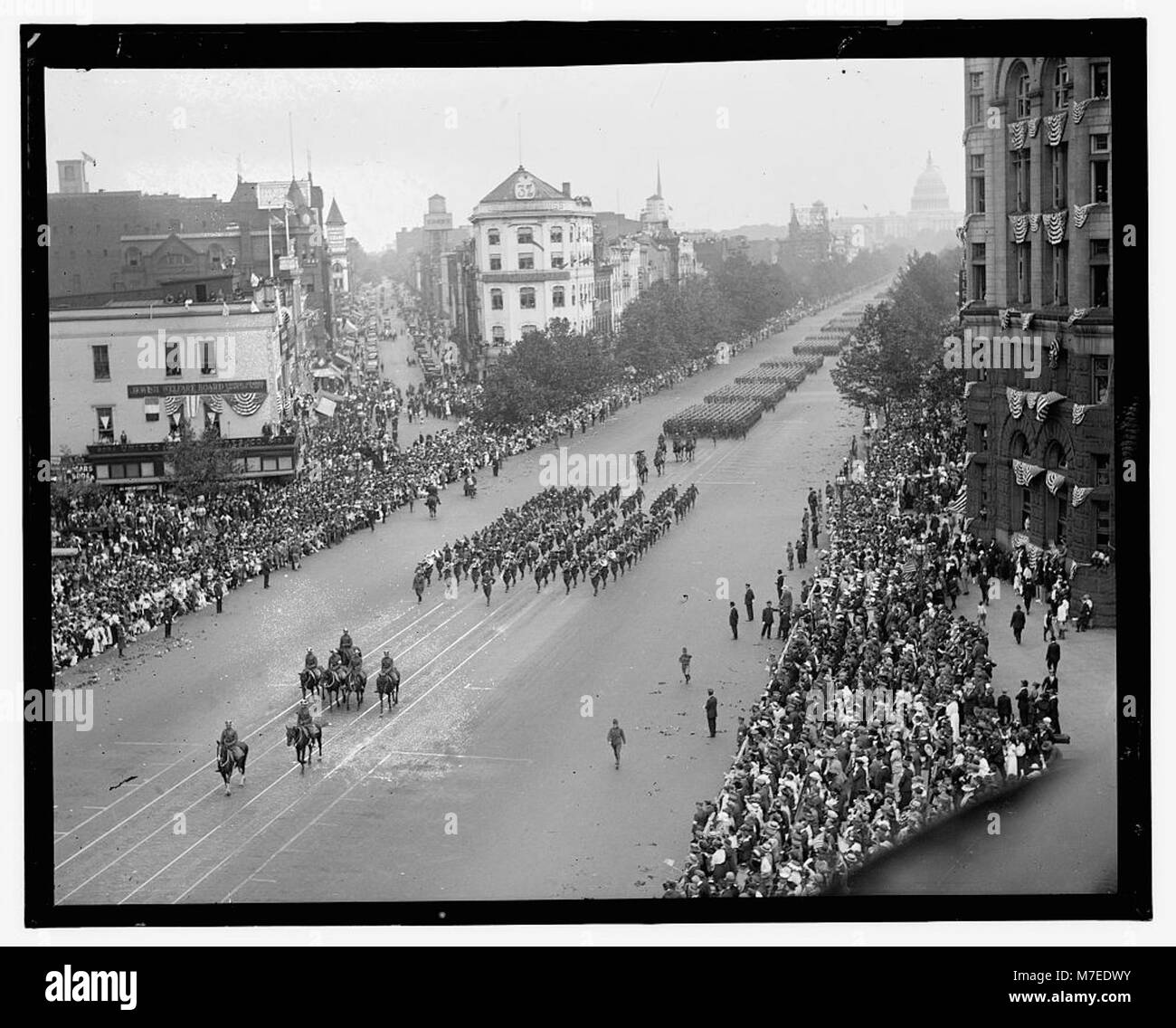 A photograph of General John J. Pershing leading a parade down ...