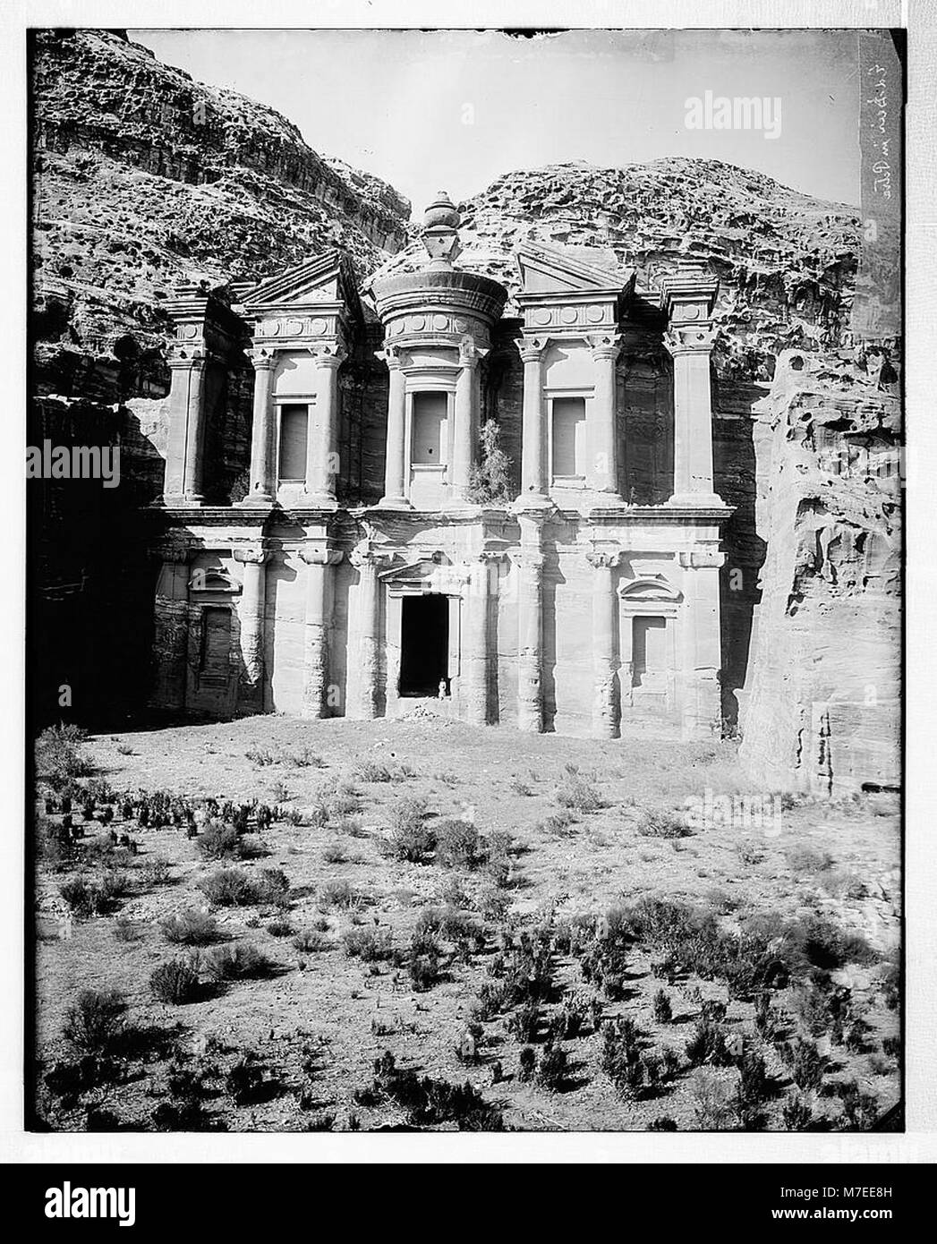 This image shows the ancient rock-cut monument of Ed-Deir in Petra ...