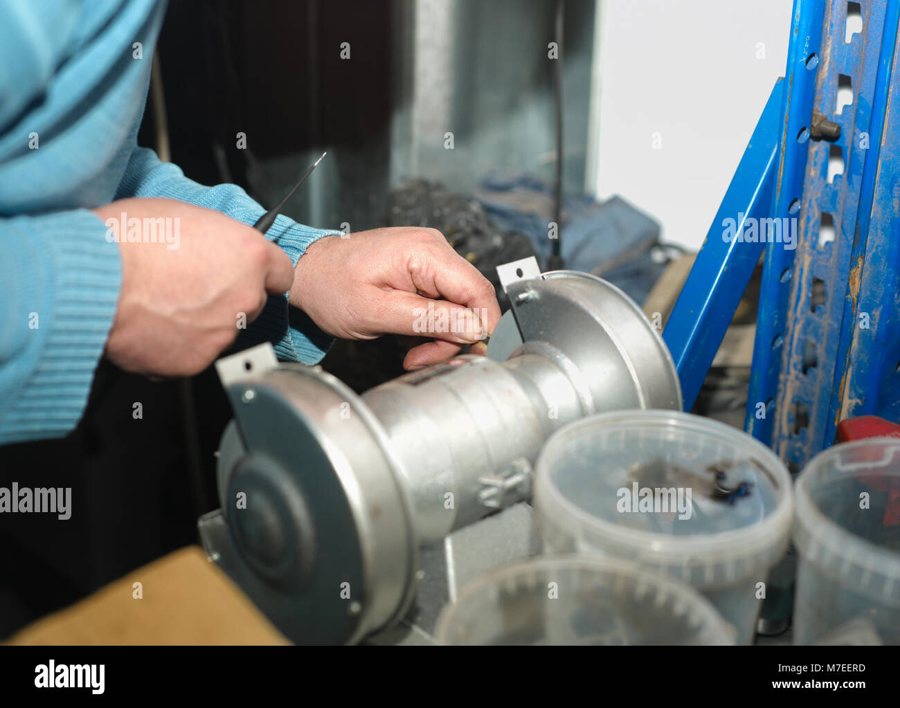 Male hands operating surface grinder, indoor clsoeup Stock Photo - Alamy