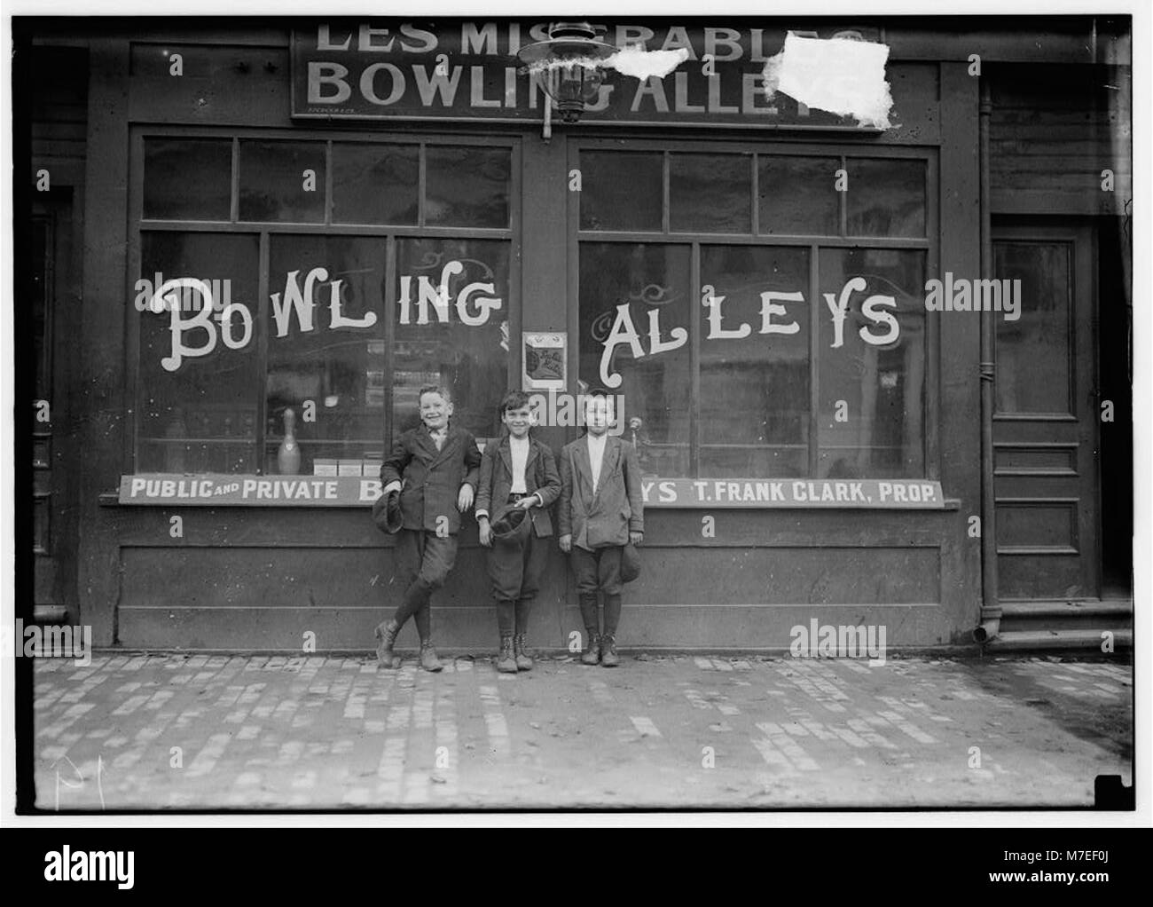 Photograph of two 11-year-old pin boys working in the alleys of Les ...
