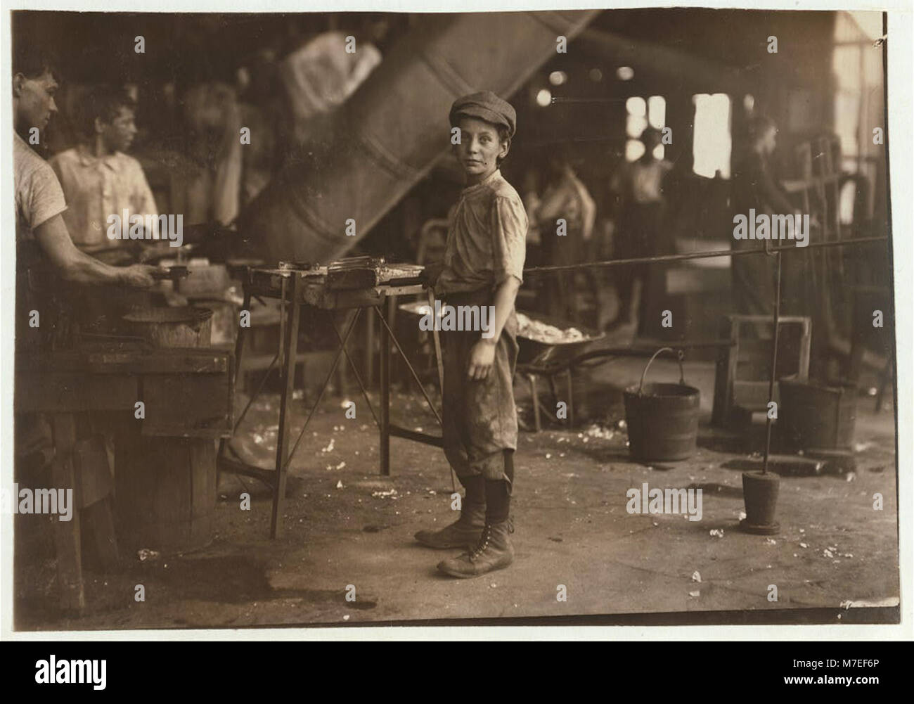 A photograph of a young boy working at the Alexandria Glass Factory in ...