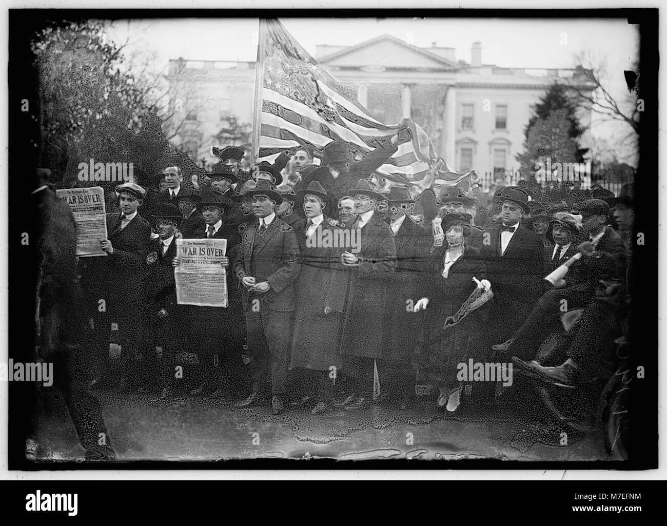 A historical photograph showing the 'WAR IS OVER' headline, marking the ...