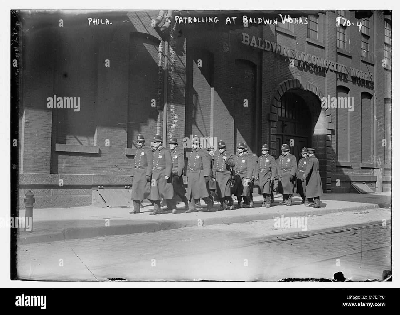 This image shows a police patrol marching outside Baldwin Locomotive ...
