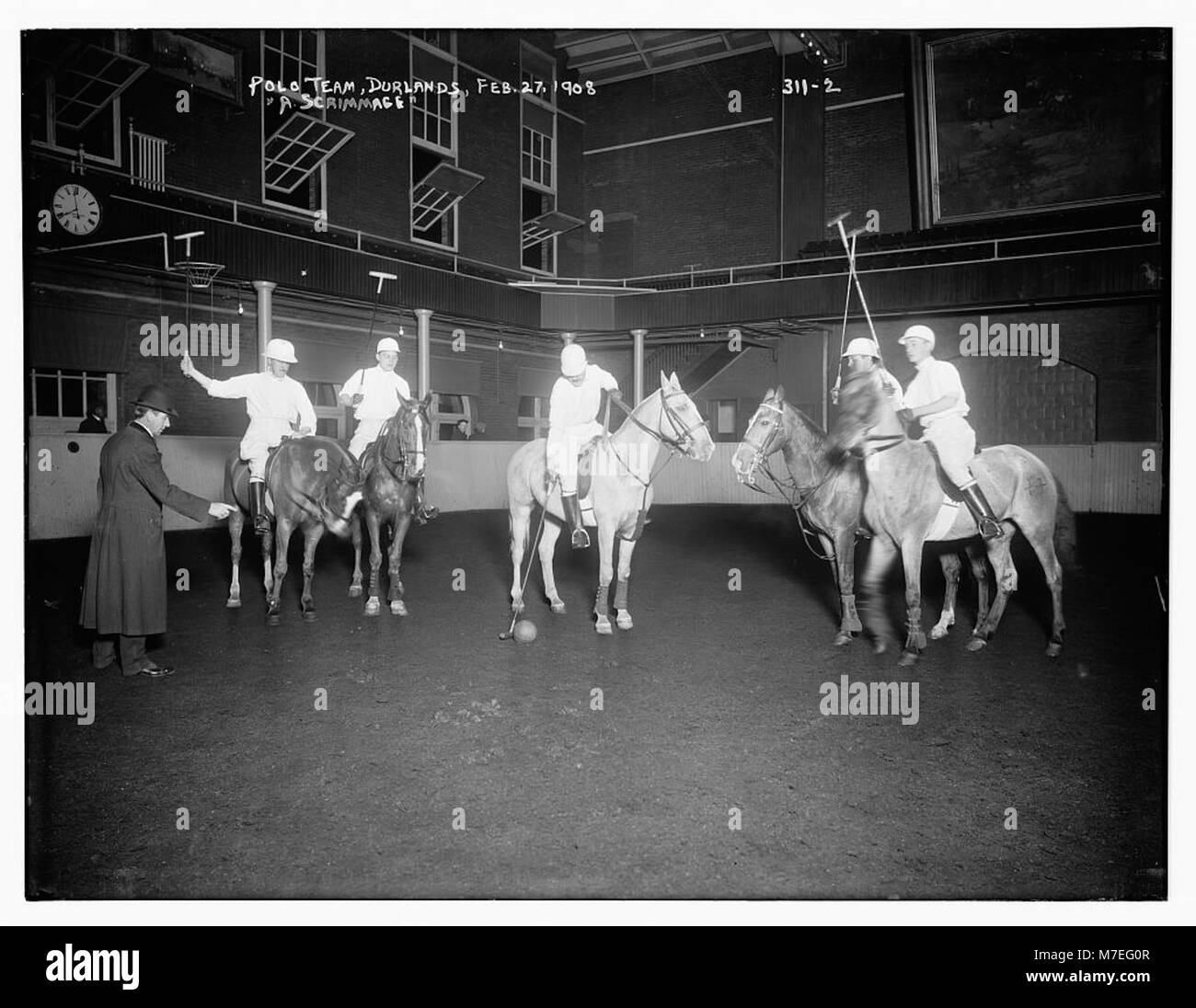 The photograph captures a moment from a polo game in 1908, showing ...