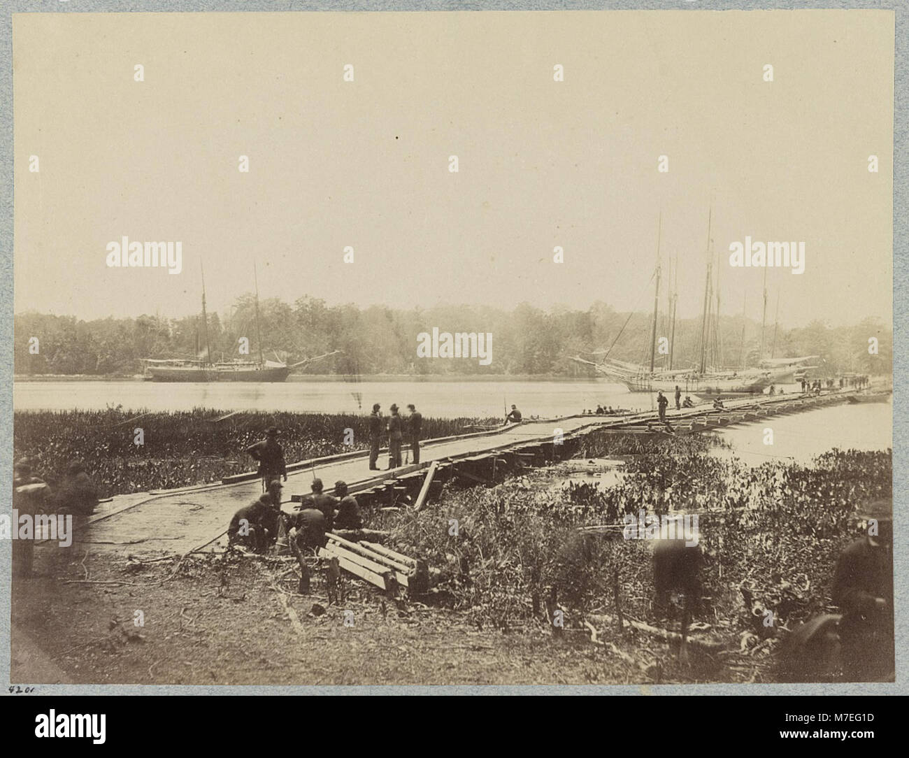 This historical image captures the pontoon bridge across the James ...