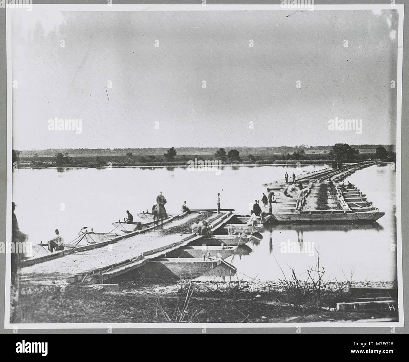 A pontoon bridge, a temporary bridge structure, is shown spanning a ...