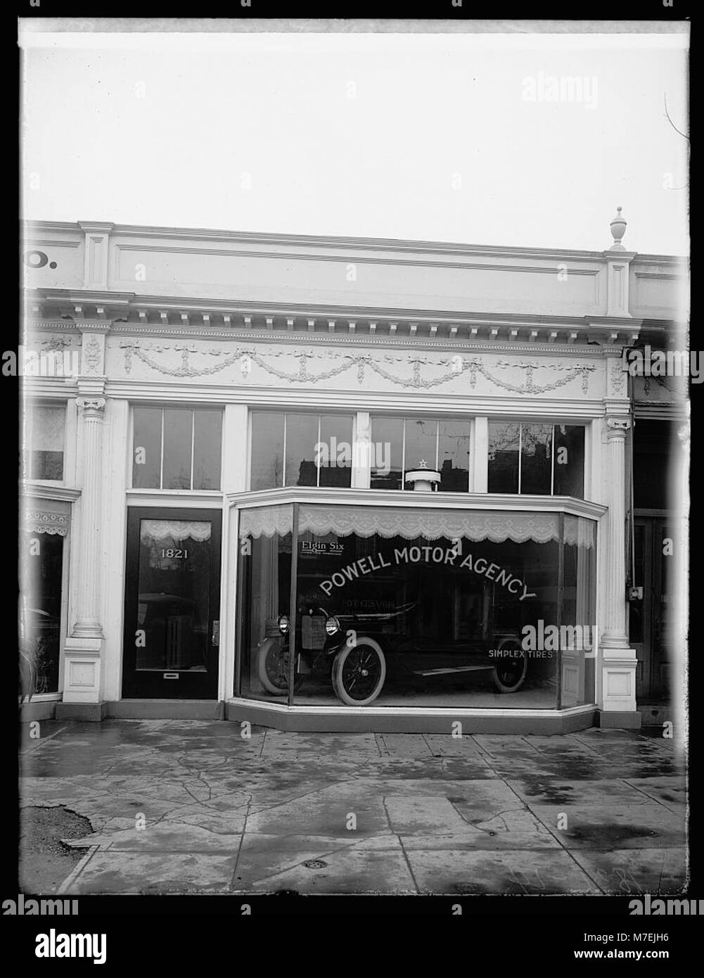 A photograph showing the front of the Powell Motor Agency, featuring an ...