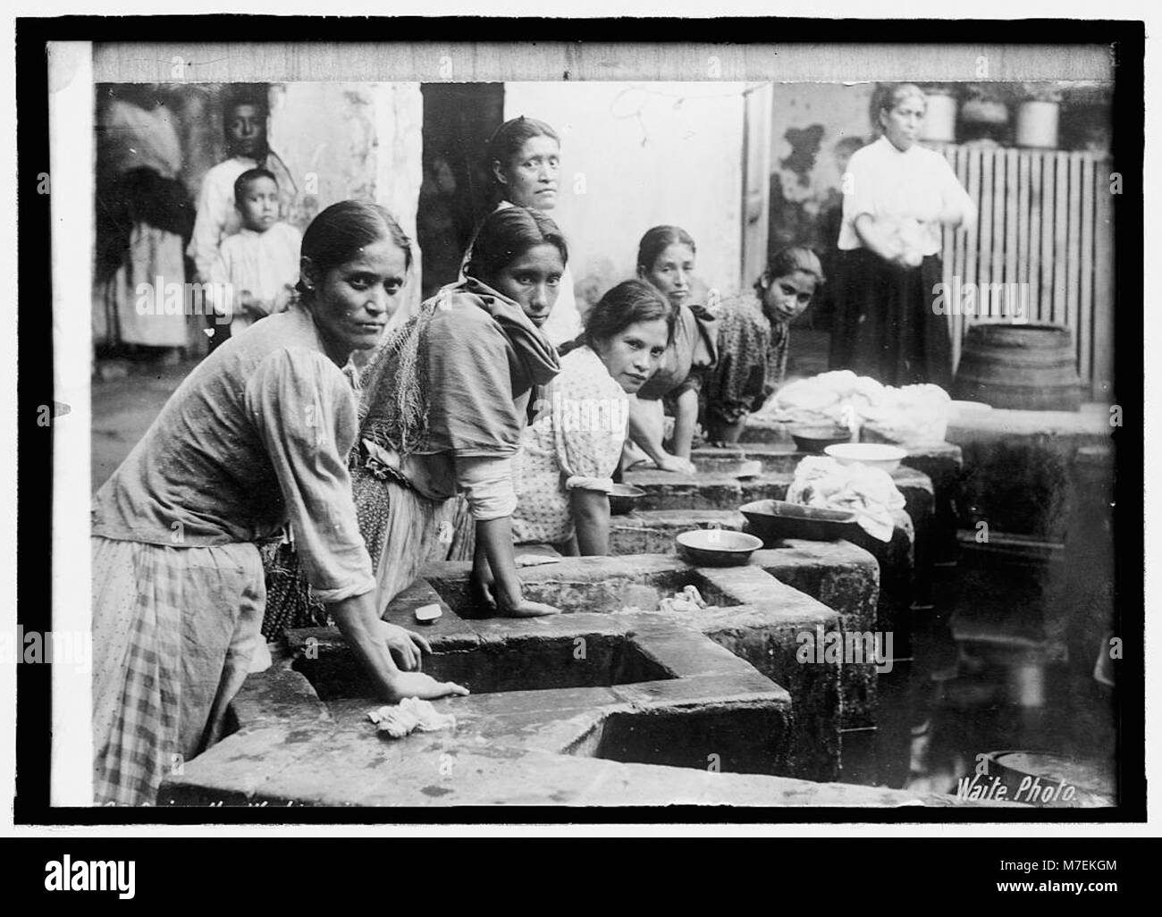 A photograph depicting a public laundry scene in Mexico City ...