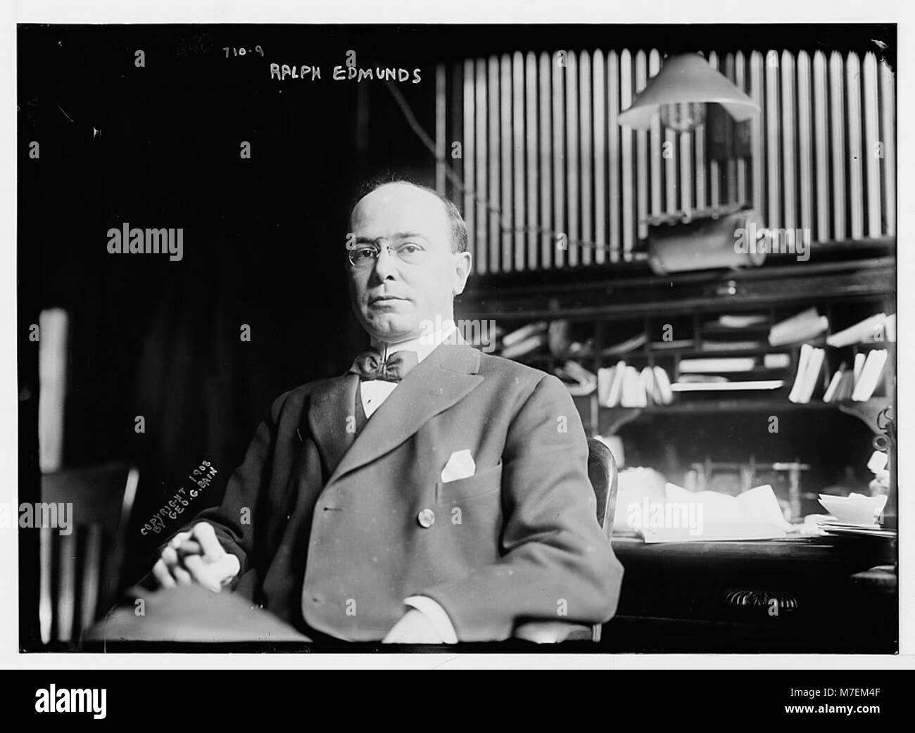 Ralph Edmunds, a historical figure, is depicted seated at his desk ...