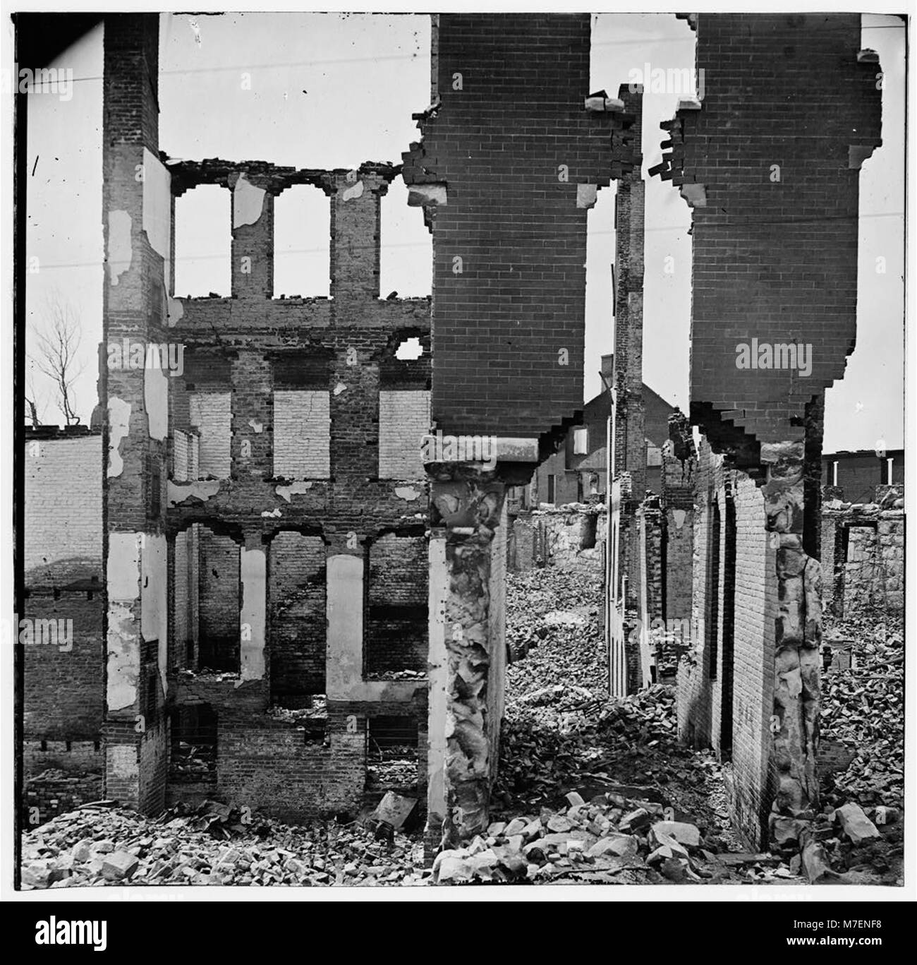 The photograph depicts the ruined buildings in the burnt district of ...