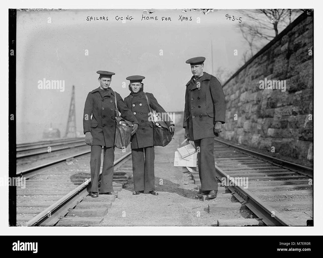 This image shows sailors at train tracks, likely during World War I or ...
