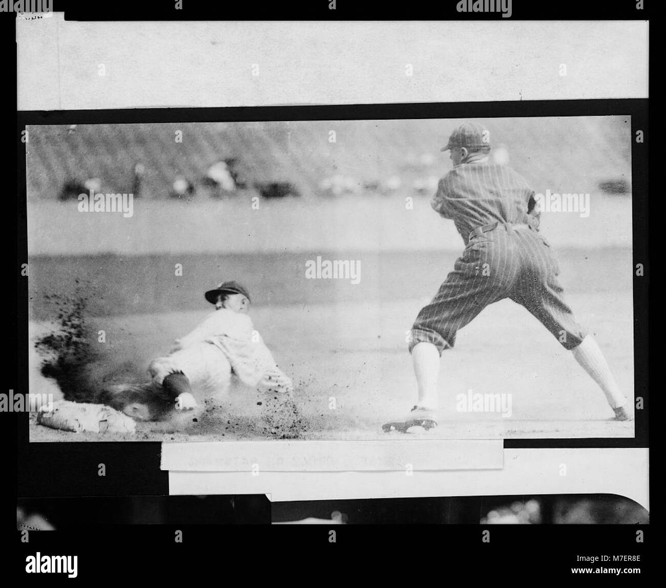 Sam Rice of the Washington Nationals is shown sliding into third base ...