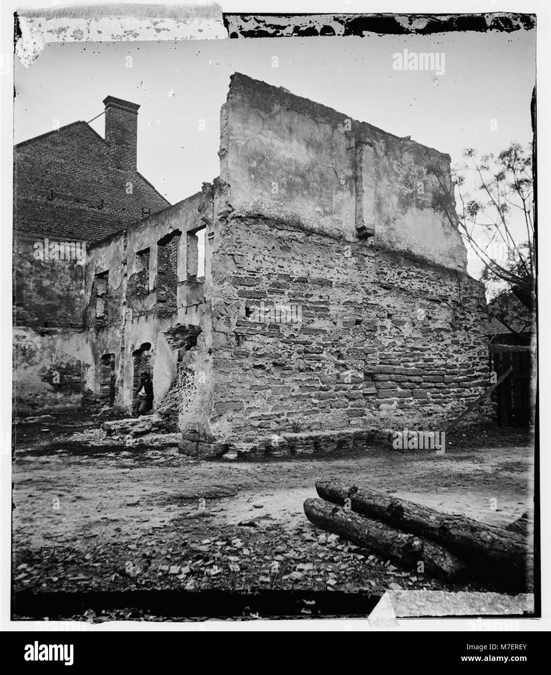 The photograph shows the ruins of houses in Savannah, Georgia, likely ...