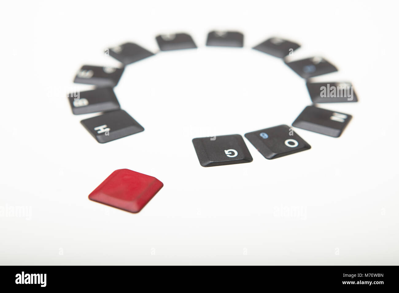 Circle of loose alphanumeric computer keyboard key covers with one ...