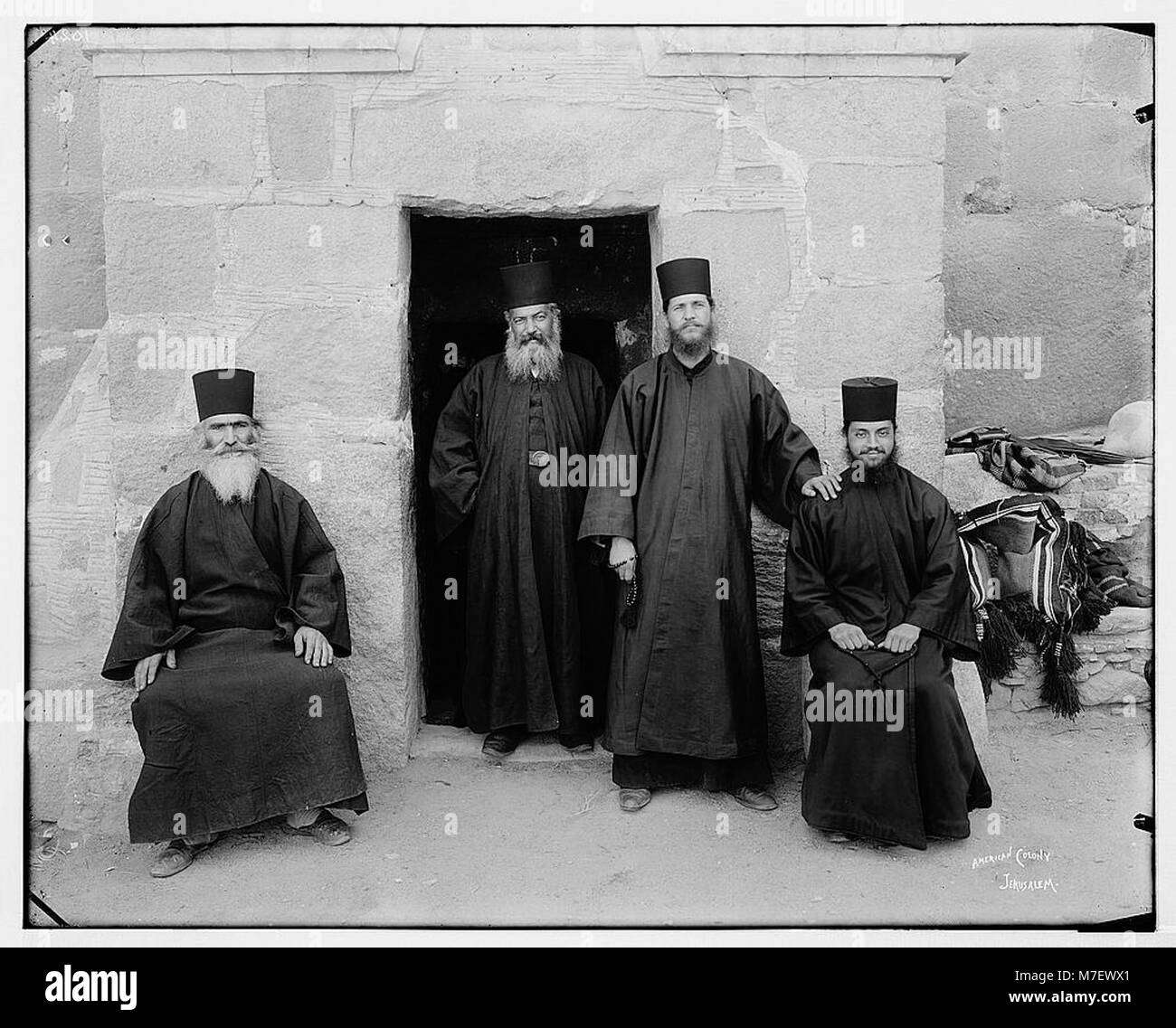 A photograph of Greek monks at the modern entrance to the Monastery of ...