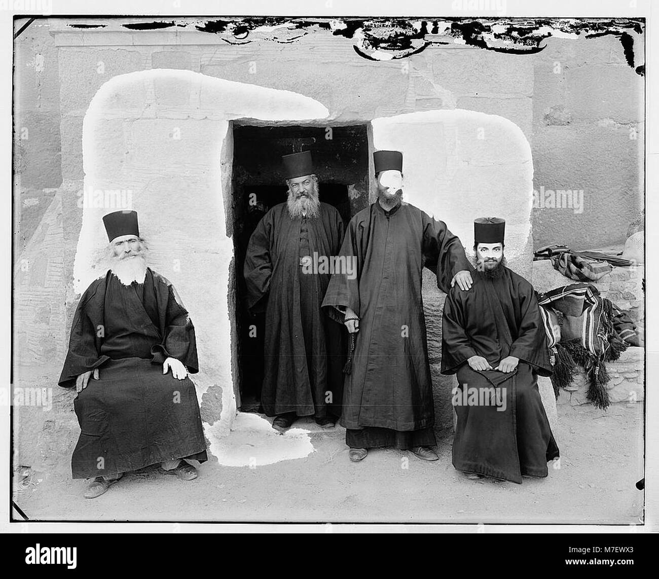 A photograph showing Greek monks at the modern entrance of the ...