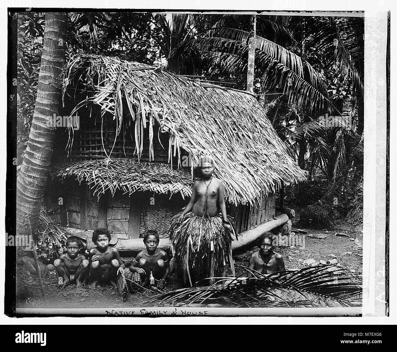 A photograph of a native family and their traditional house on the ...