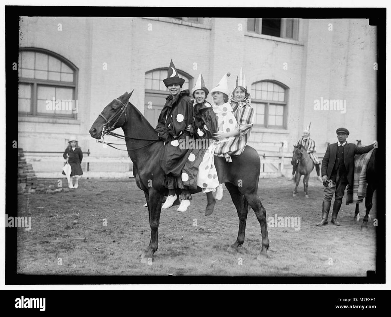 This image depicts clowns performing on horseback at a society circus ...
