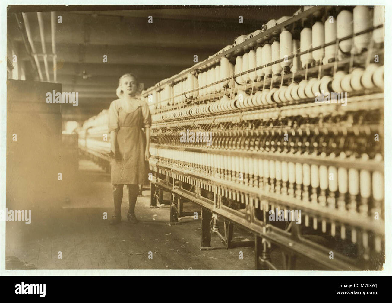 This photograph shows Sophie, a young spinner working in a spinning ...