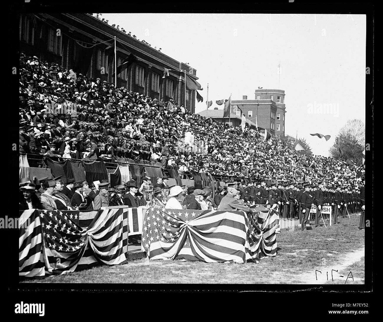 A photograph showing a group of spectators seated in bleachers, likely ...