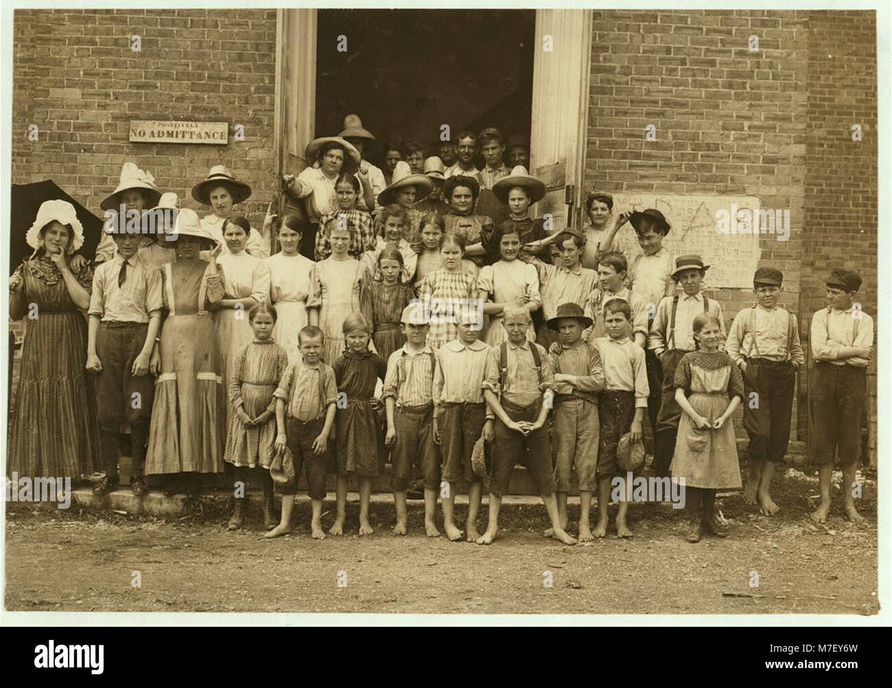 Photograph of a spinning room overseer and his workers, illustrating ...