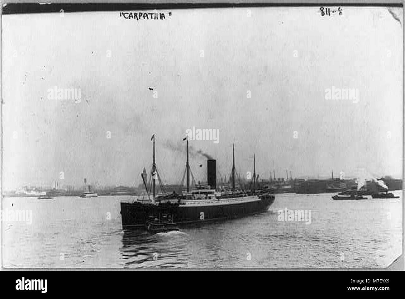 The Steamship Carpathia is shown in a bow view with two tugboats ...