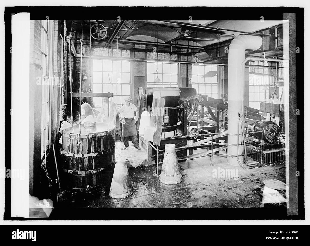 A photograph depicting the process of hat-making at Stetson Hat Company ...