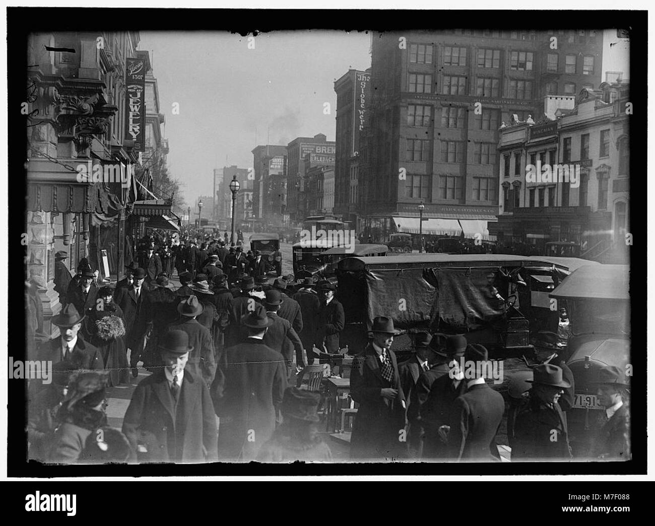 A photograph of a bustling street scene in Washington, D.C., showing ...