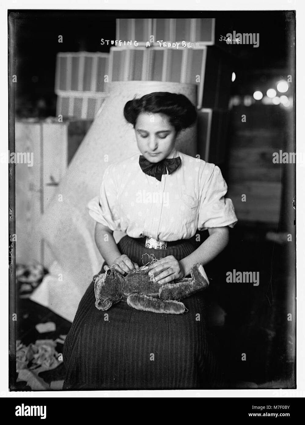 A photograph showing the process of stuffing a teddy bear, highlighting ...