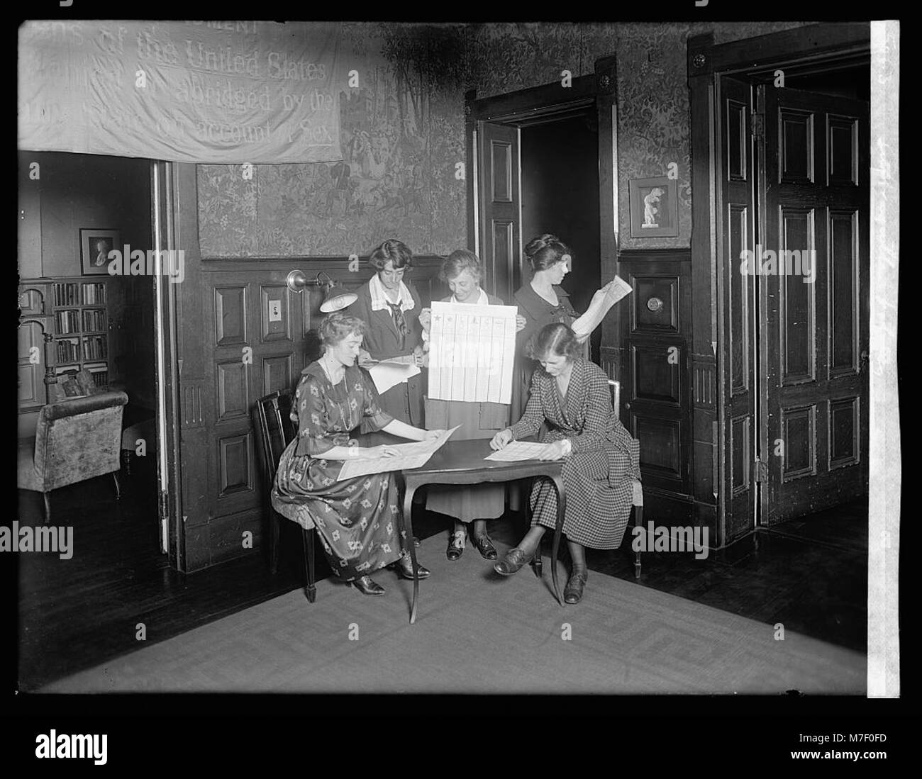 A historical photograph of suffragettes voting, symbolizing the ...