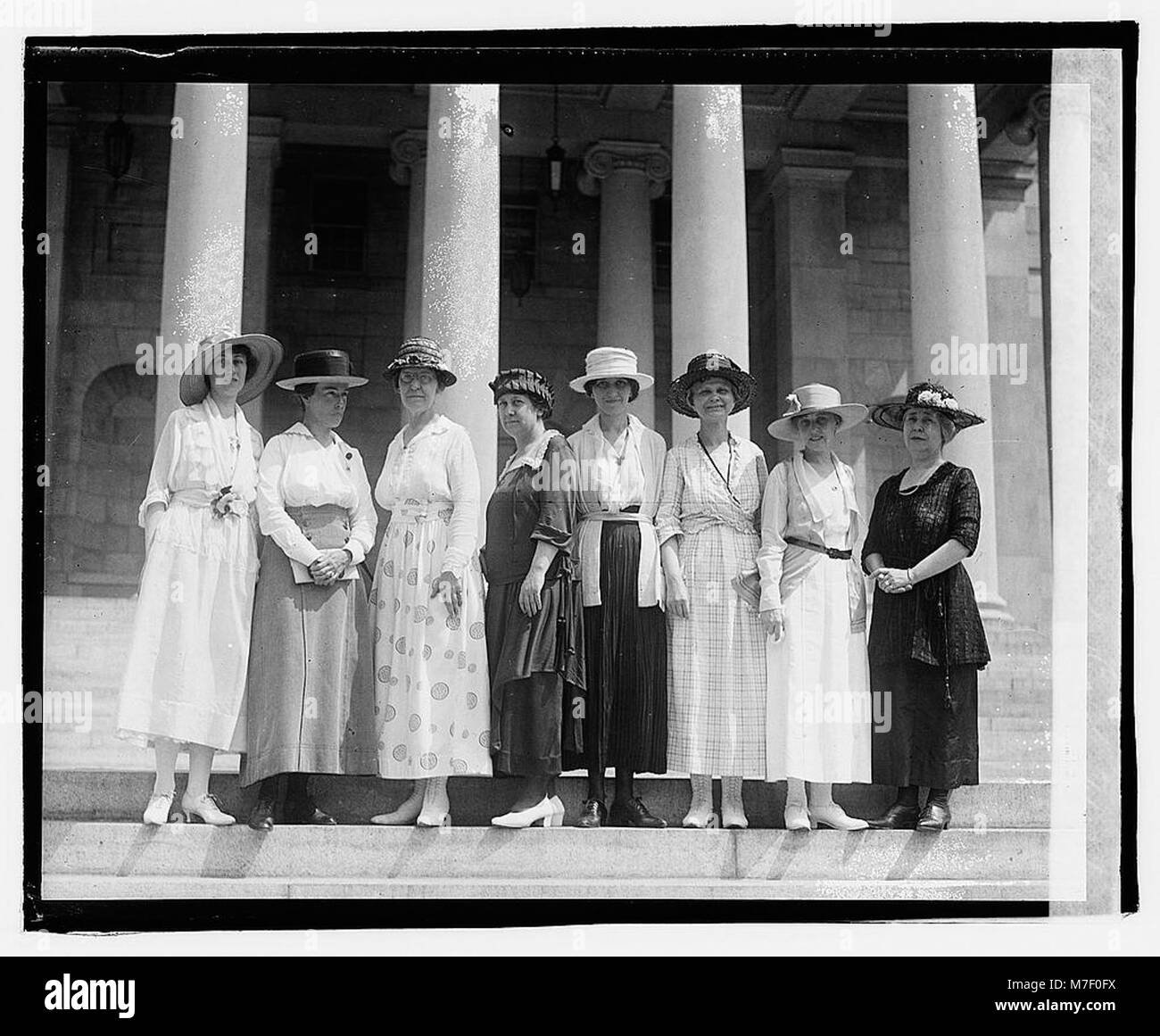 This image depicts a group of suffragettes, women's rights activists ...