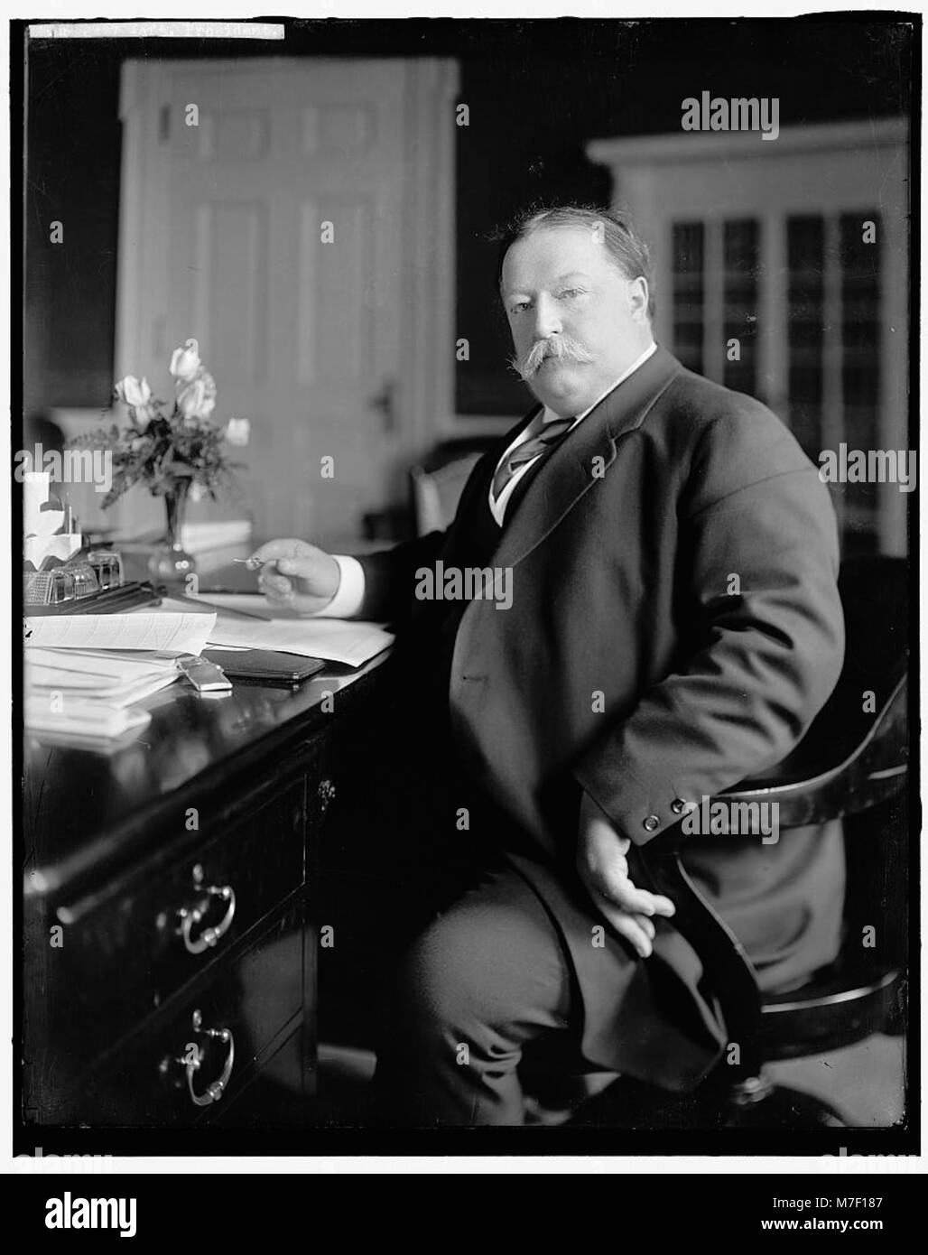 A portrait of President William H. Taft sitting at his desk, capturing ...