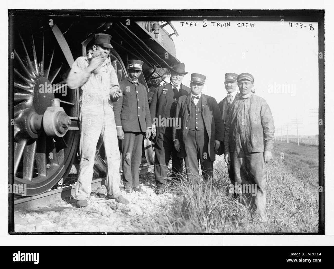 A photograph featuring William Howard Taft and a train crew ...