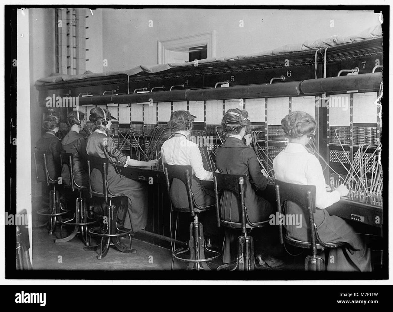 A photograph showing telephone operators at work, highlighting the role ...