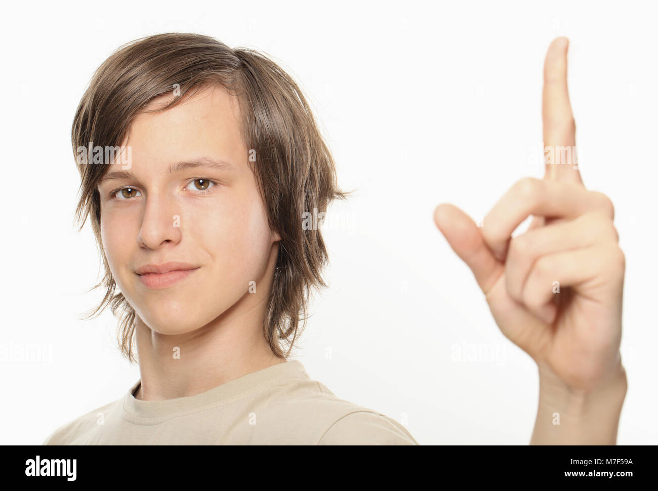 Young boy showing upwards with index finger Stock Photo - Alamy