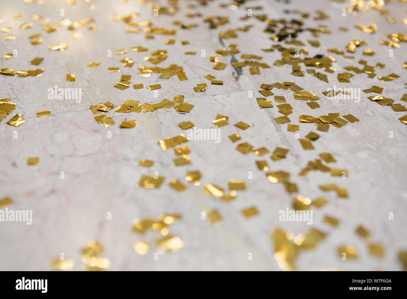 the gold confetti on the floor. background Stock Photo - Alamy