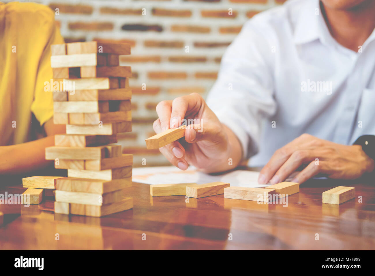 Group of business creative people building tower by wooden blocks ...