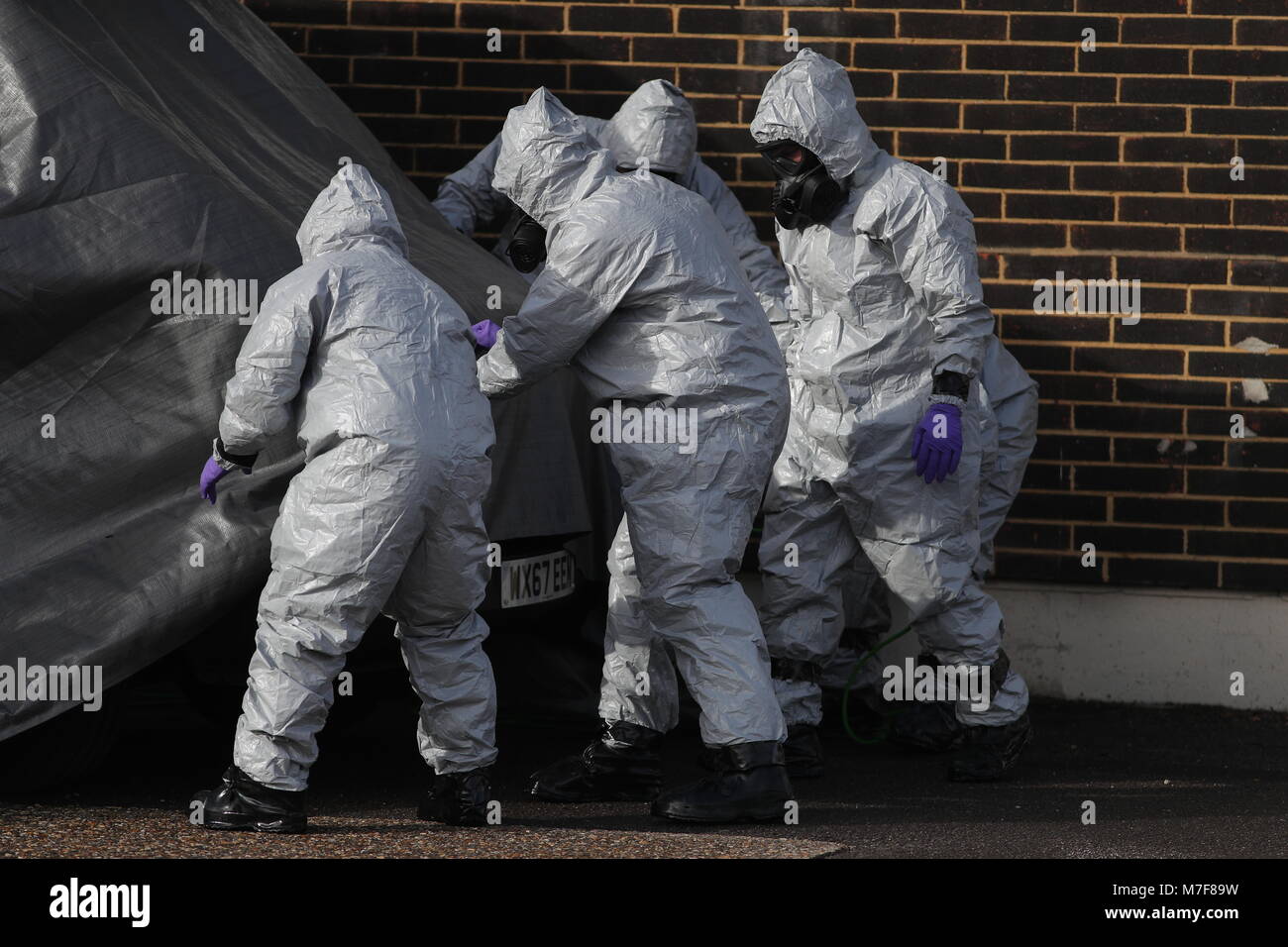 Investigators in gas masks examine an ambulance at the South Western ...