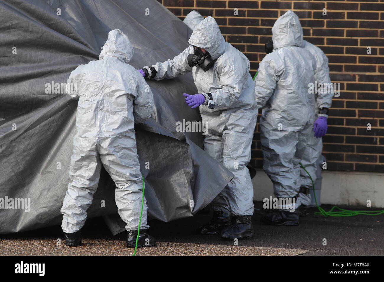 Investigators in gas masks examine an ambulance at the South Western ...