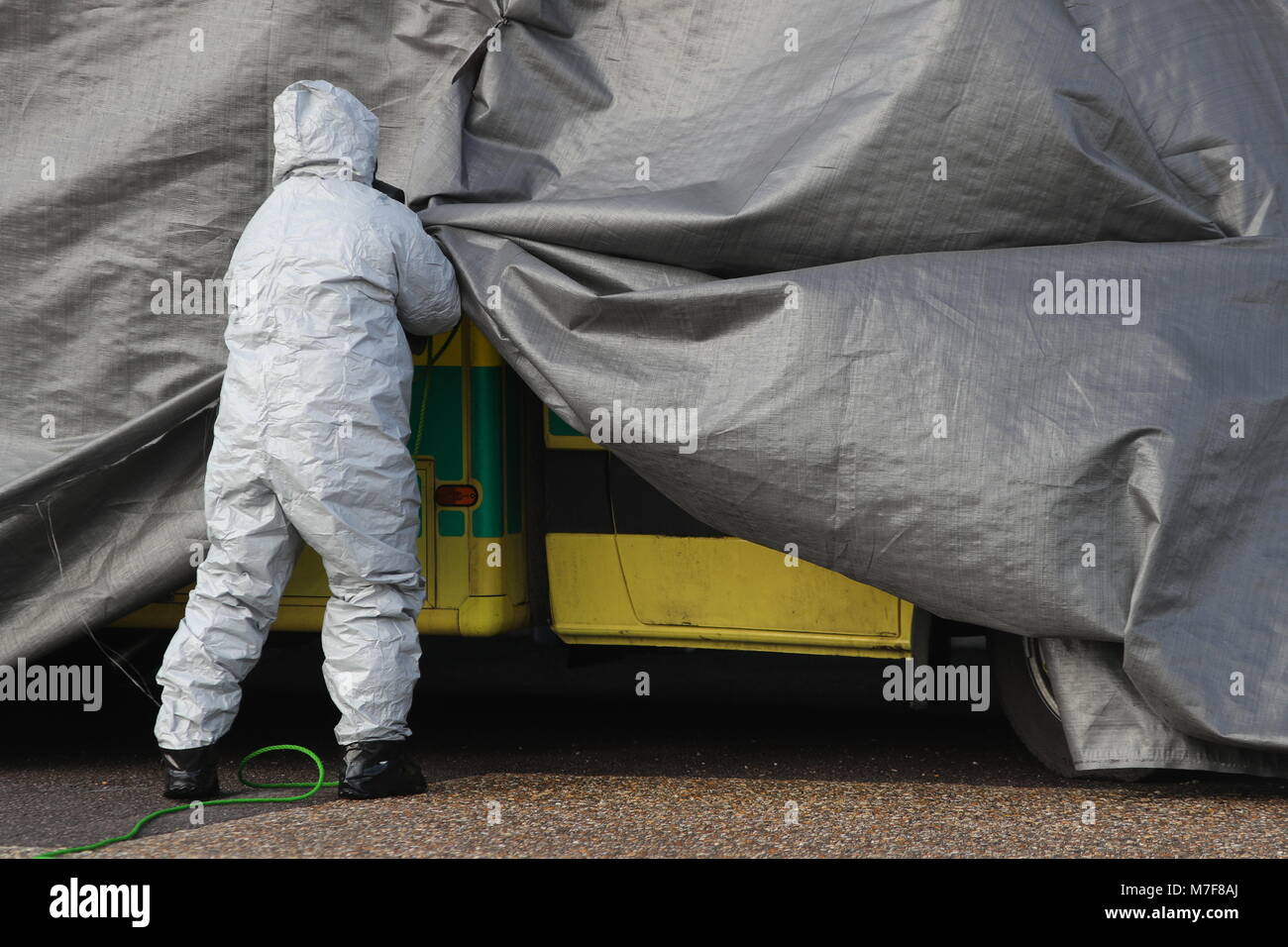 Investigators in gas masks examine an ambulance at the South Western ...