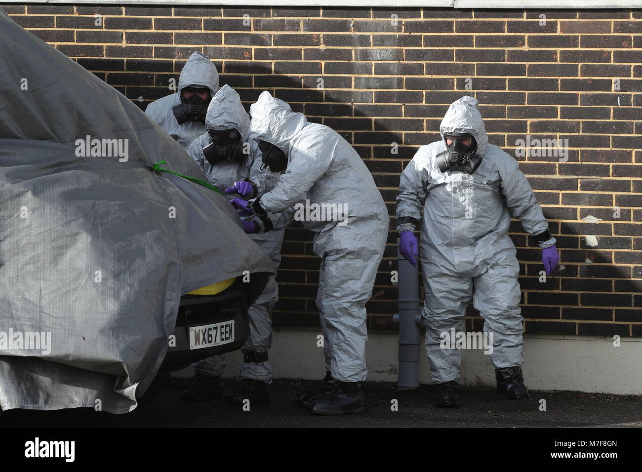 Investigators in gas masks examine an ambulance at the South Western ...