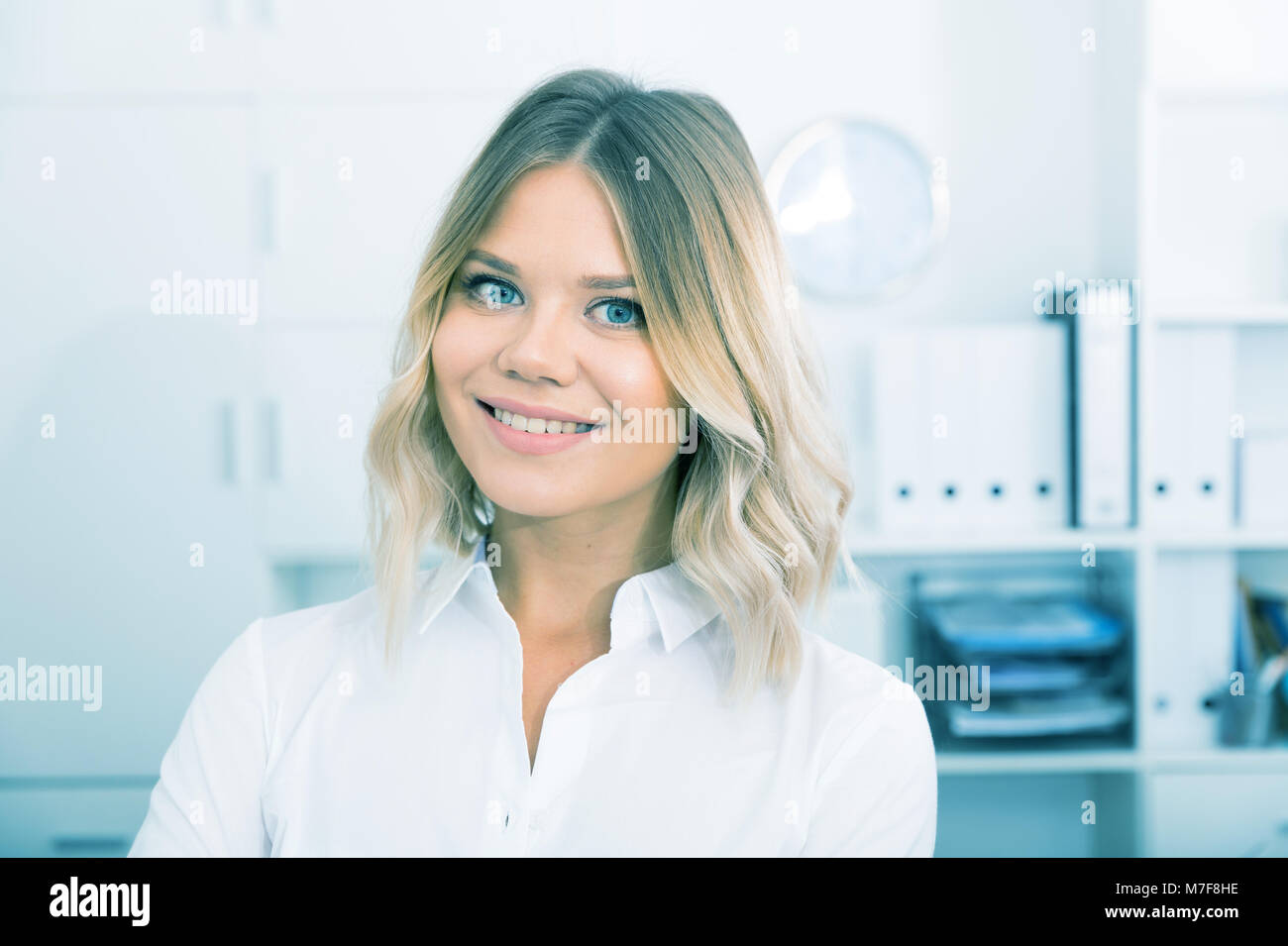 Kindness girl in white shirt in modern office close-up Stock Photo - Alamy