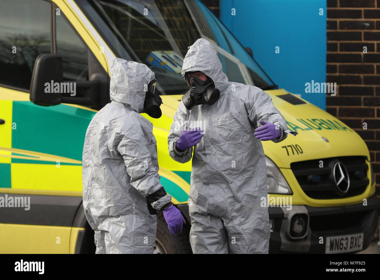 Investigators in gas masks prepare to move an ambulance at the South ...
