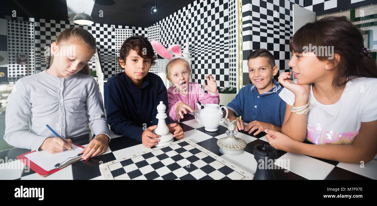 five captured children play in quest room in chess style Stock Photo ...