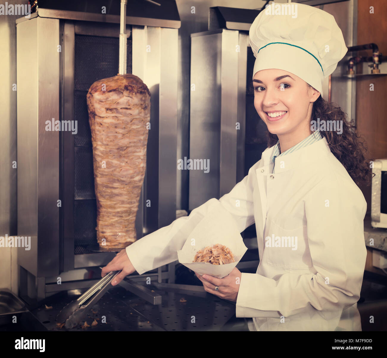 Cheerful young female chef preparing shawarma at bistro Stock Photo - Alamy