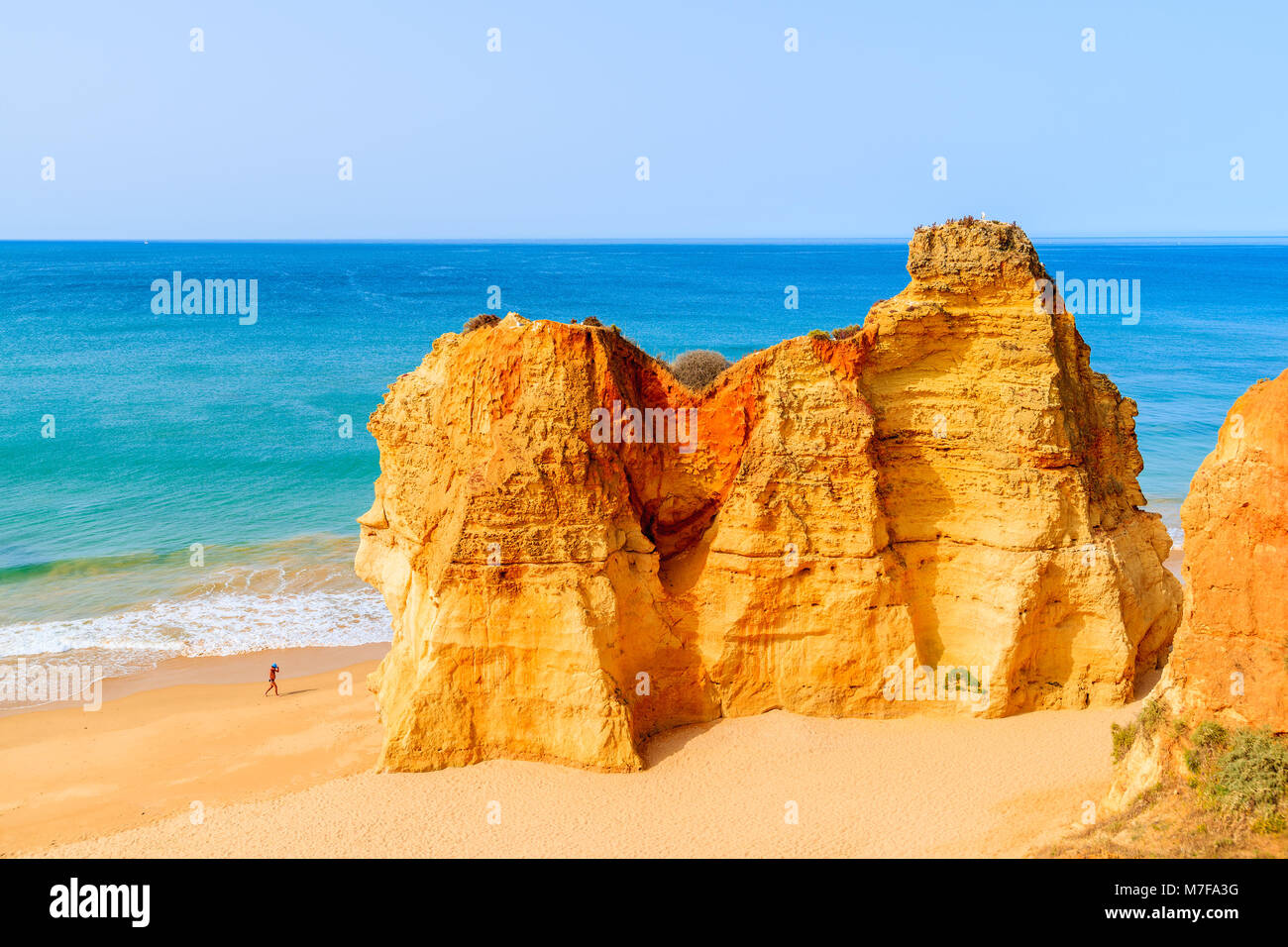 Rocks on beautiful sandy Praia da Rocha beach in Portimao town, Algarve ...